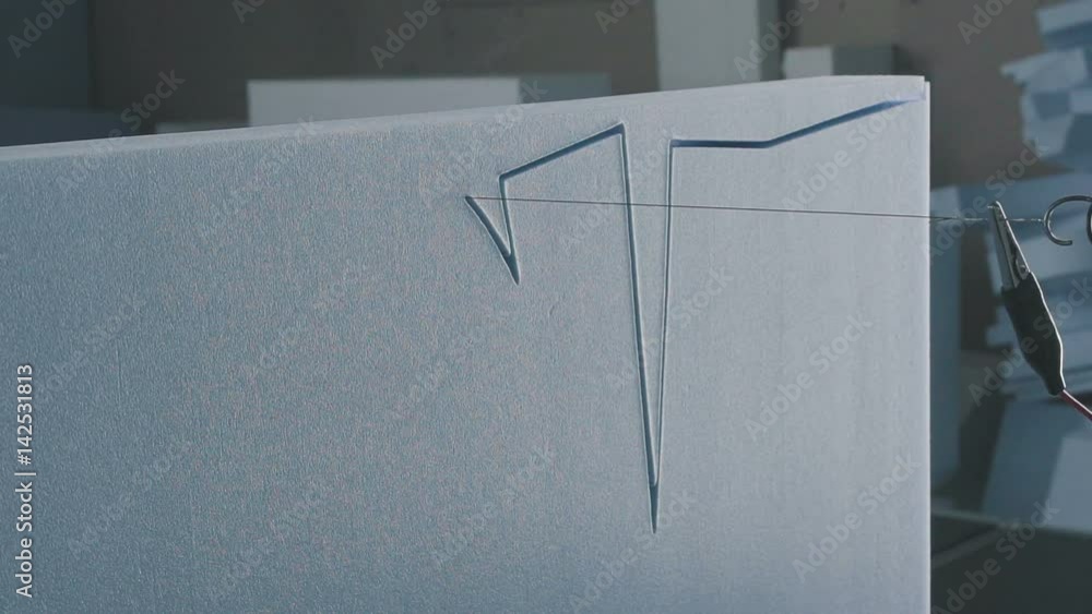 Cutting out volumetric letters of foam plastic. Figured cutting of foam ...