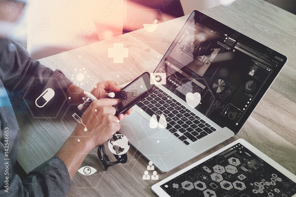 doctor working with smart phone and laptop and digital tablet computer ...