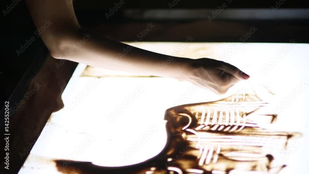 Drawing with sand. Short show. Drawing sand on a white screen. Sand ...