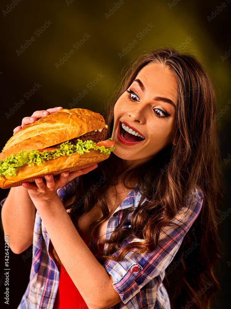 Woman eating hamburger. Student consume fast food. Girl bite of very ...