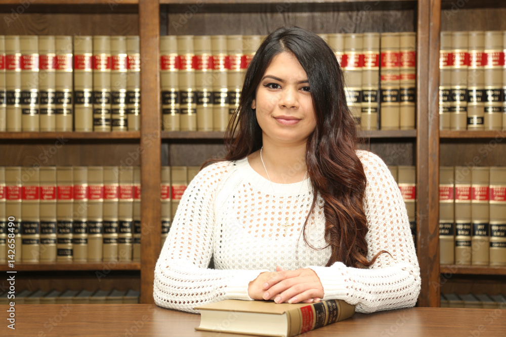 Young attractive female law student in law library Stock Photo | Adobe ...