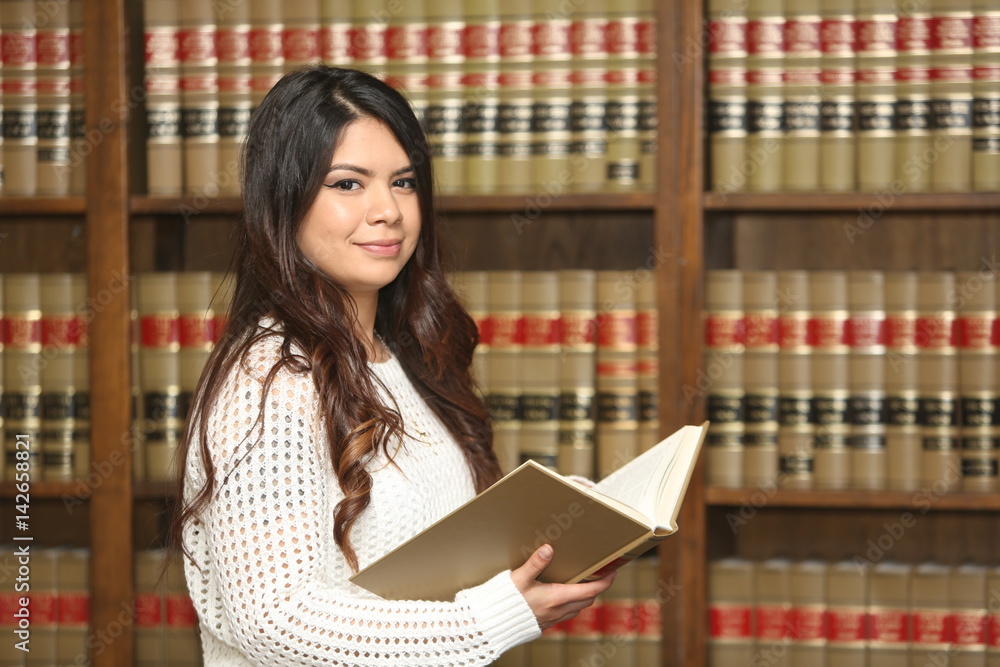 Young attractive female law student in law library Stock Photo | Adobe ...