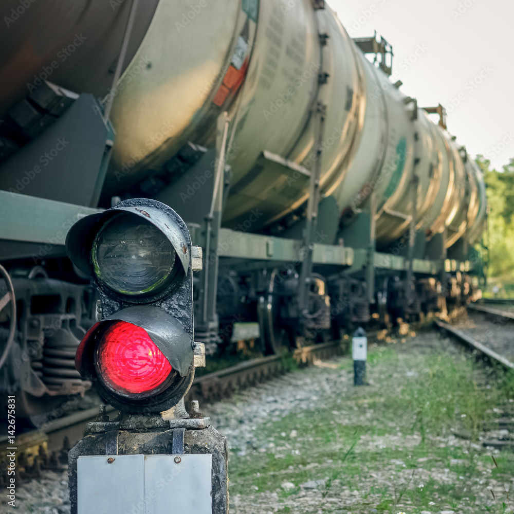 Railroad traffic light and freight train on behind Stock Photo | Adobe ...