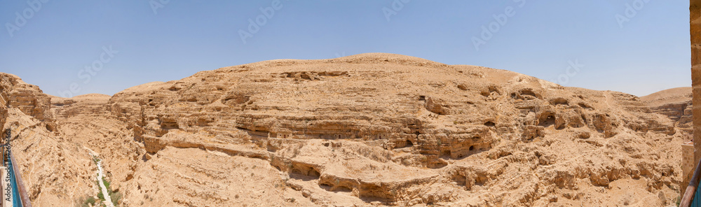 Kidron river strata canyon panorama with monastic cave-cells in the ...