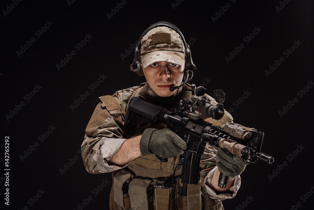 Portrait soldier or private military contractor holding sniper rifle ...