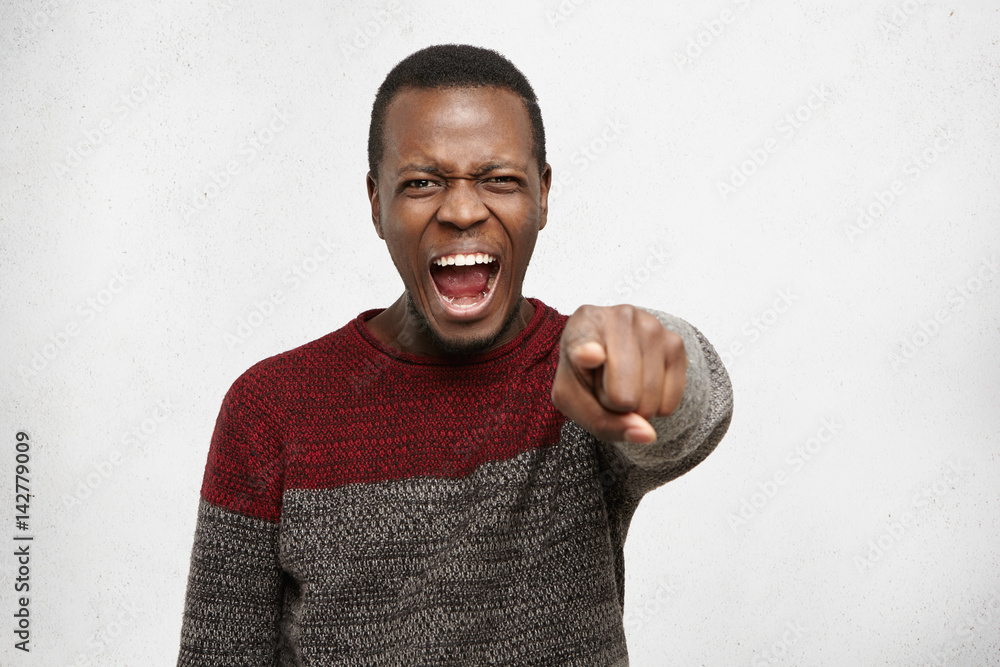 This is your fault. Aggressive angry dark-skinned male shouting and ...