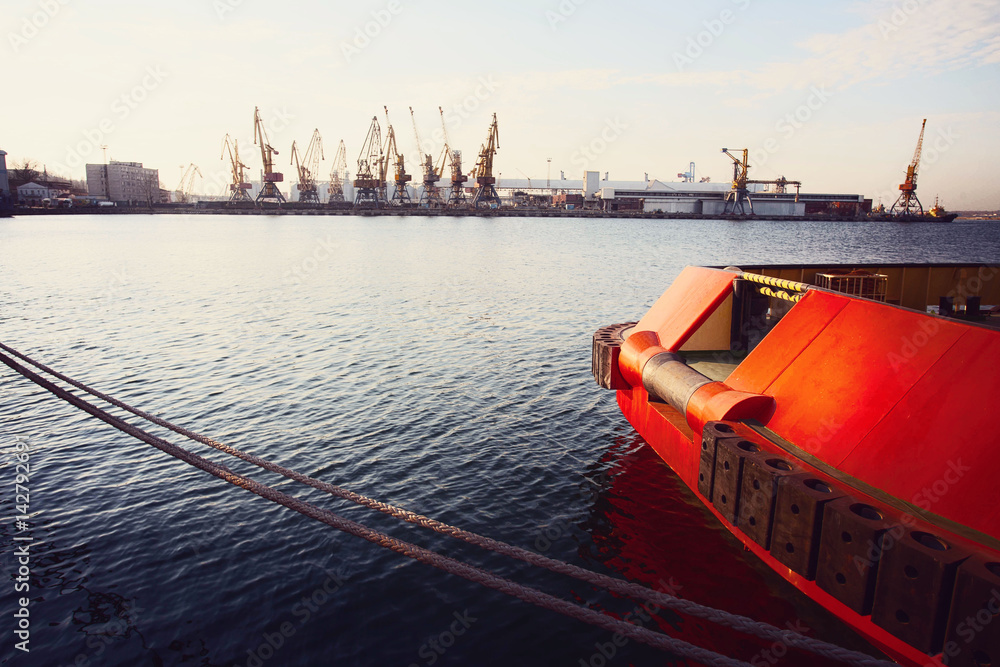 Container Cargo Ship with working crane bridge in shipyard background ...