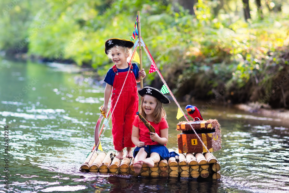 Kids playing pirate adventure on wooden raft Stock Photo | Adobe Stock