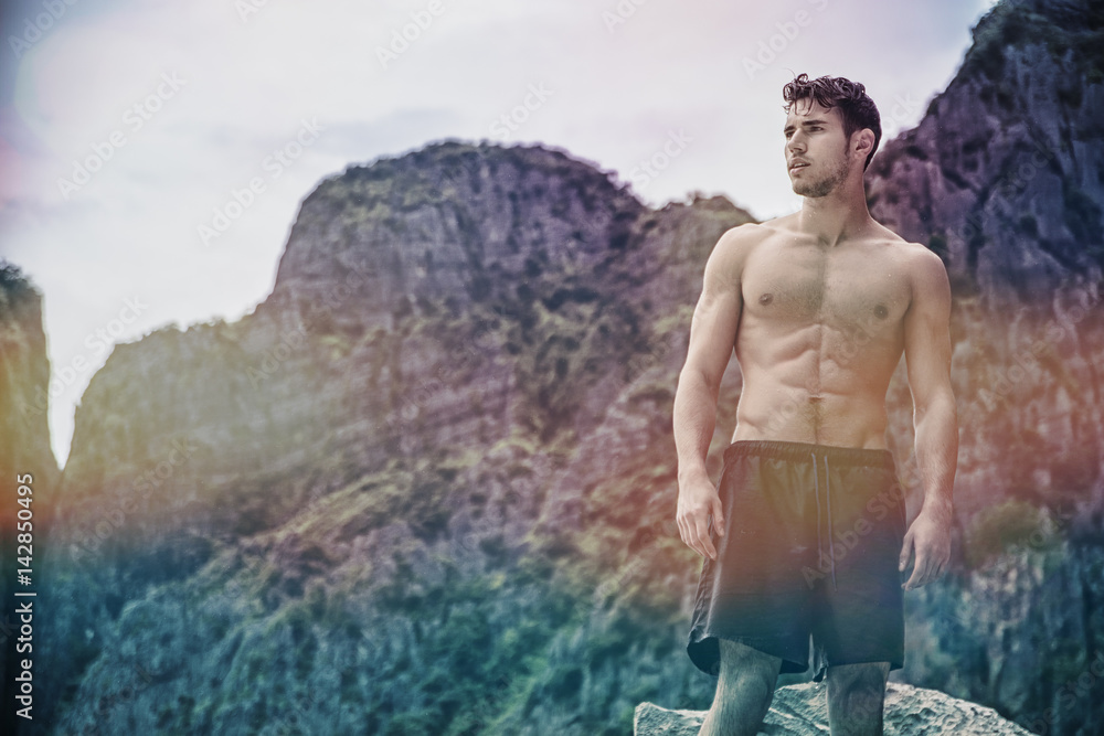 Half body shot of a handsome young man standing on a beach in Phuket ...