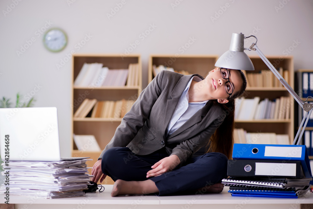 Busy angry businesswoman sitting on the desk in office Stock Photo ...