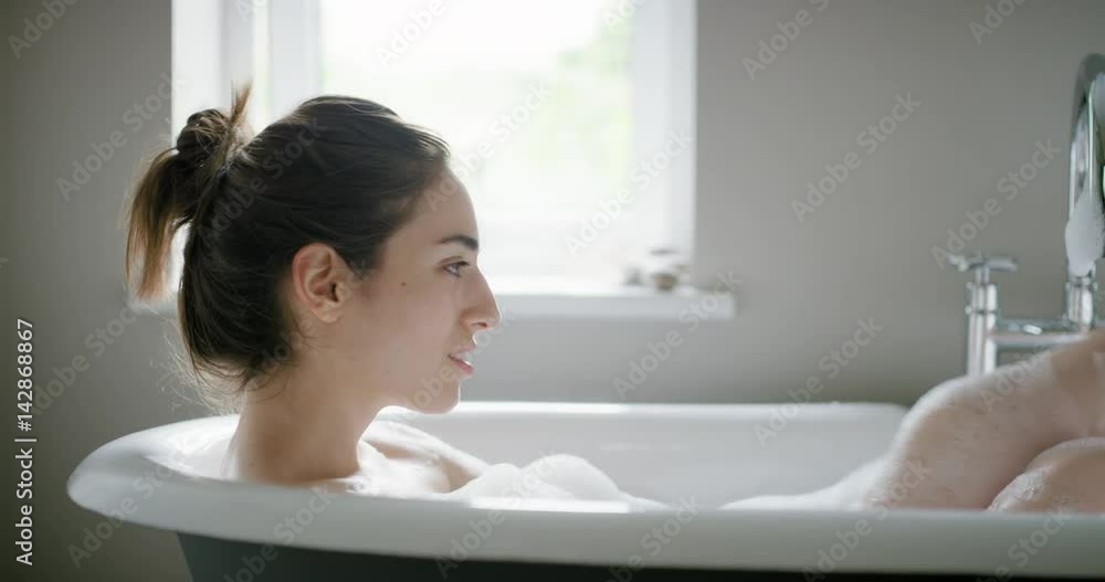 Beautiful Woman lying in bathtub enjoying relaxing bubble bath ...