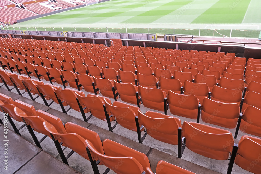 Red seats at football stadium. Stock Photo | Adobe Stock