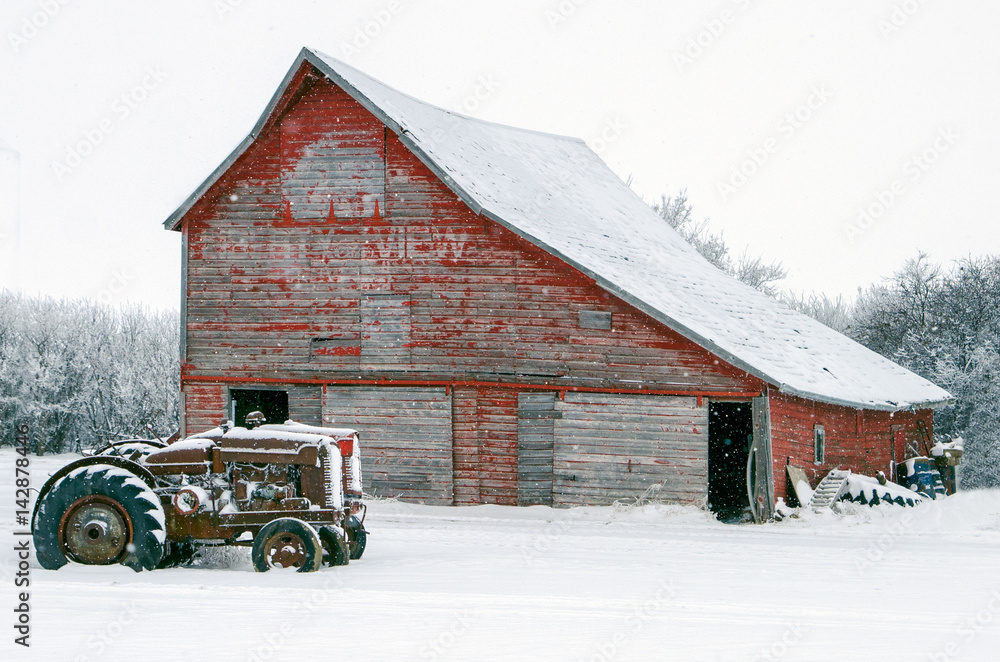 Vintage tractors in front of an old red barn in snow Stock Photo ...