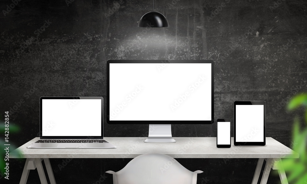 Different devices on desk with isolated screen for responsive web site design promotion ...