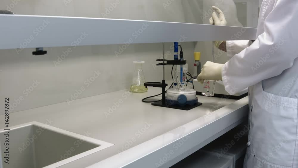 Analytical laboratory. Mixing of the solution. Adding substance to the ... Analytical laboratory. Mixing of the solution. Adding substance to the ...