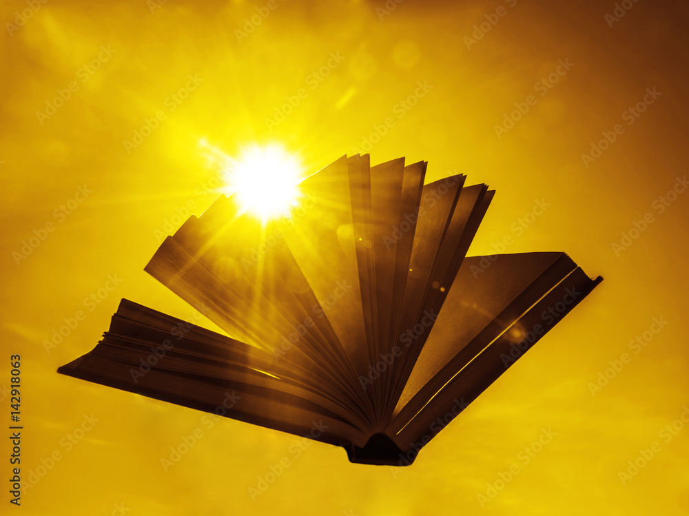 open book in front of sky. sunny blue and yellow sky, sun rays. Stock ...