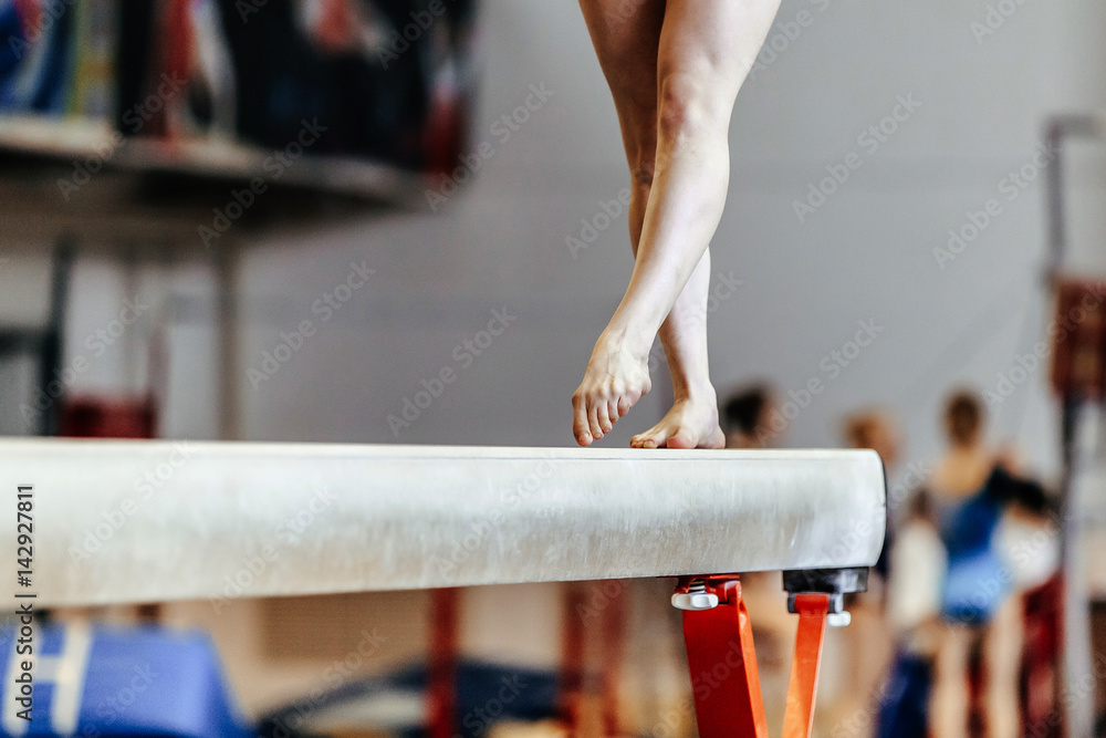 feet woman gymnast exercises on balance beam competition in artistic ...
