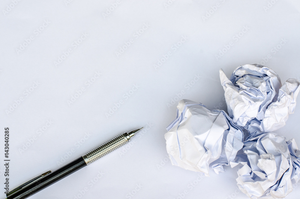 Writing concept - crumpled up paper wads with a sheet of white paper ...