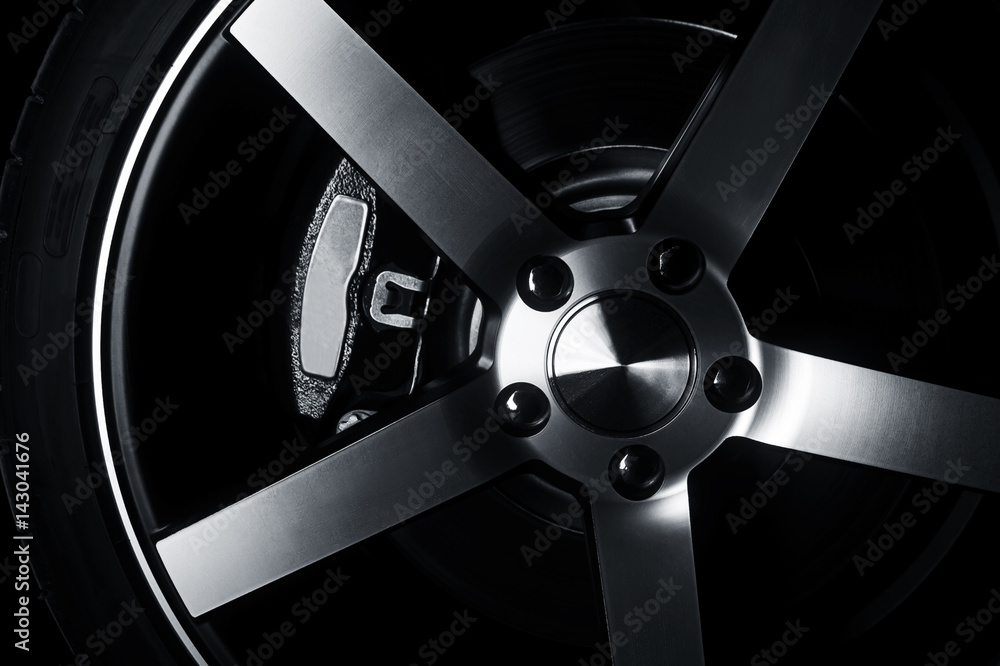 Modern metal rims on car at dark Stock Photo | Adobe Stock