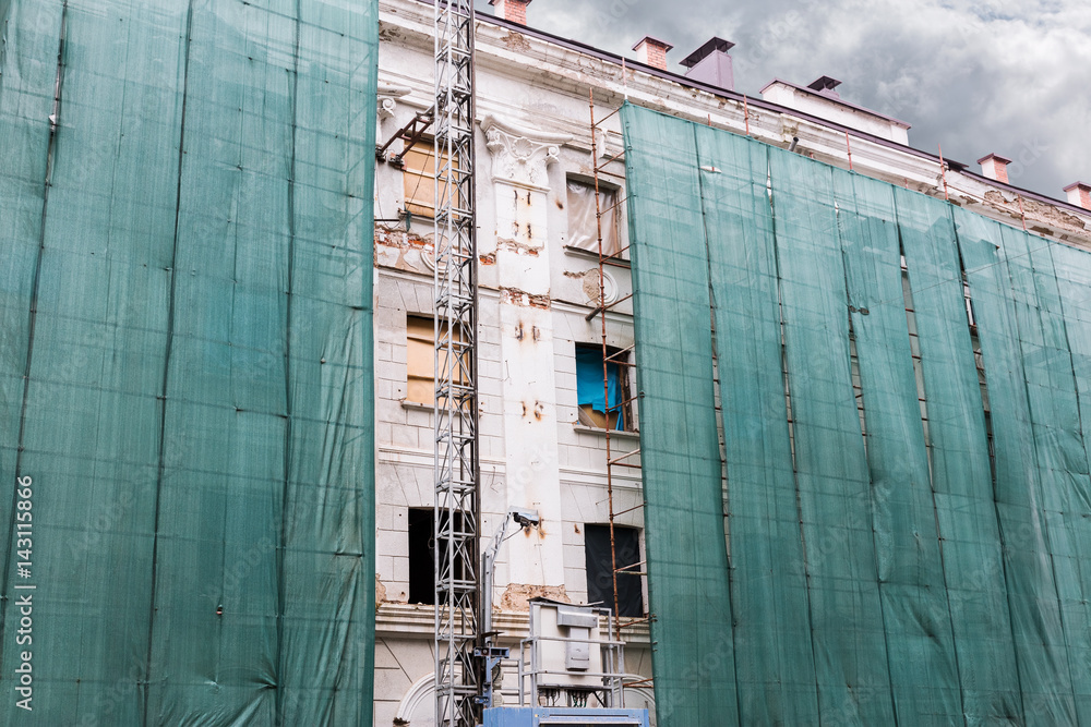 urban apartment building covered with a green cloth during ...