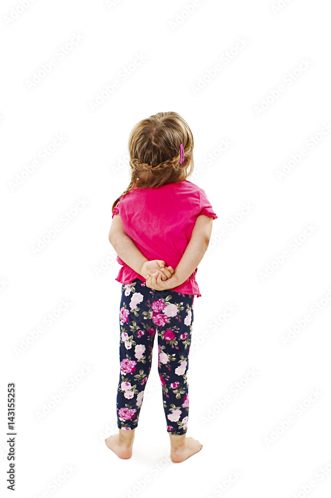 Back view of little baby girl looking at wall. Rear view. Isolated on ...