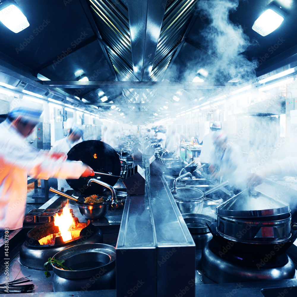Motion chefs in a Chinese restaurant kitchen. Stock Photo | Adobe Stock
