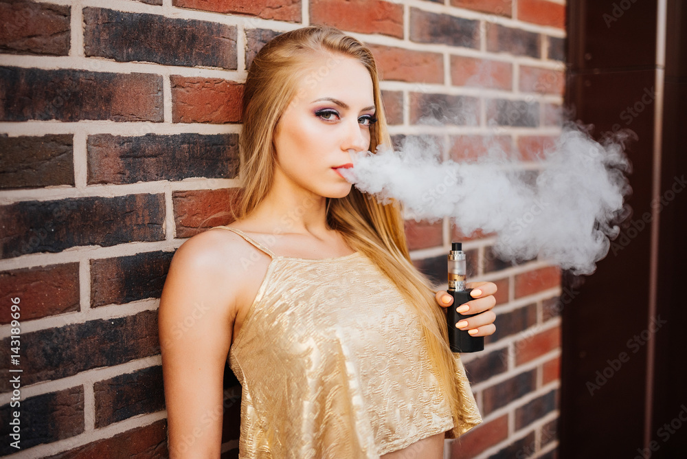Vaping Young Beautiful Girl Smoking Vaping E Cigarette With Smoke Outdoors Vapor Concept