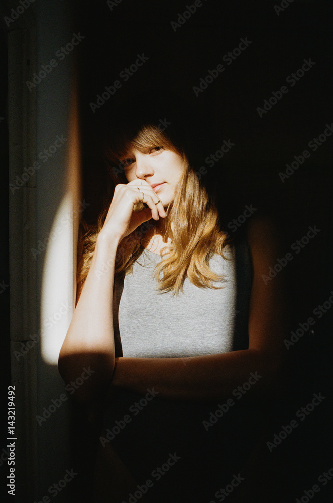 Light illuminates woman posing for a portrait Stock Photo | Adobe Stock