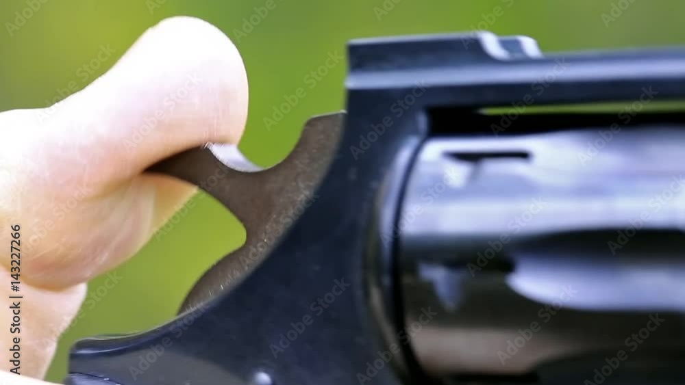 Shots from a revolver. Man shoots a revolver. Shots from a black pistol ...