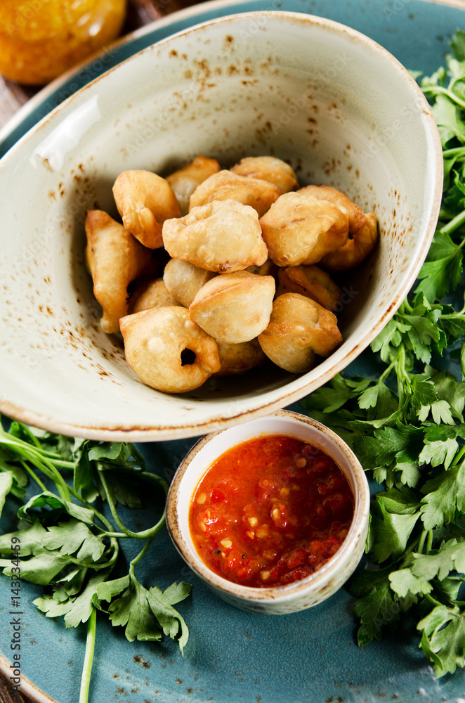 Chuchvara. Fried dumplings with lamb and spicy sauce. Traditional dish ...