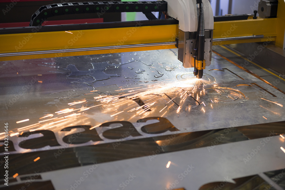 The CNC laser cut machine while cutting the sheet metal with the ...