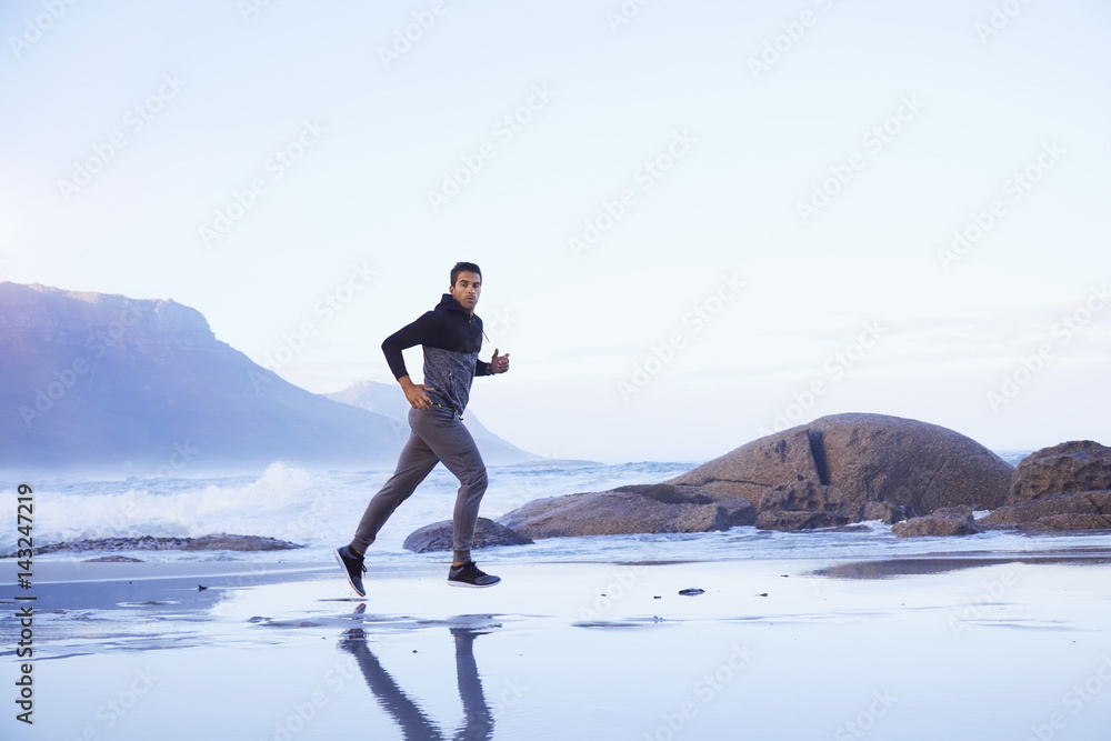 Beach jogging dude by sea Stock Photo | Adobe Stock