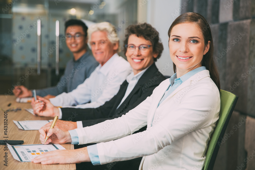 Beautiful female manager and her colleagues looking at camera Stock ...