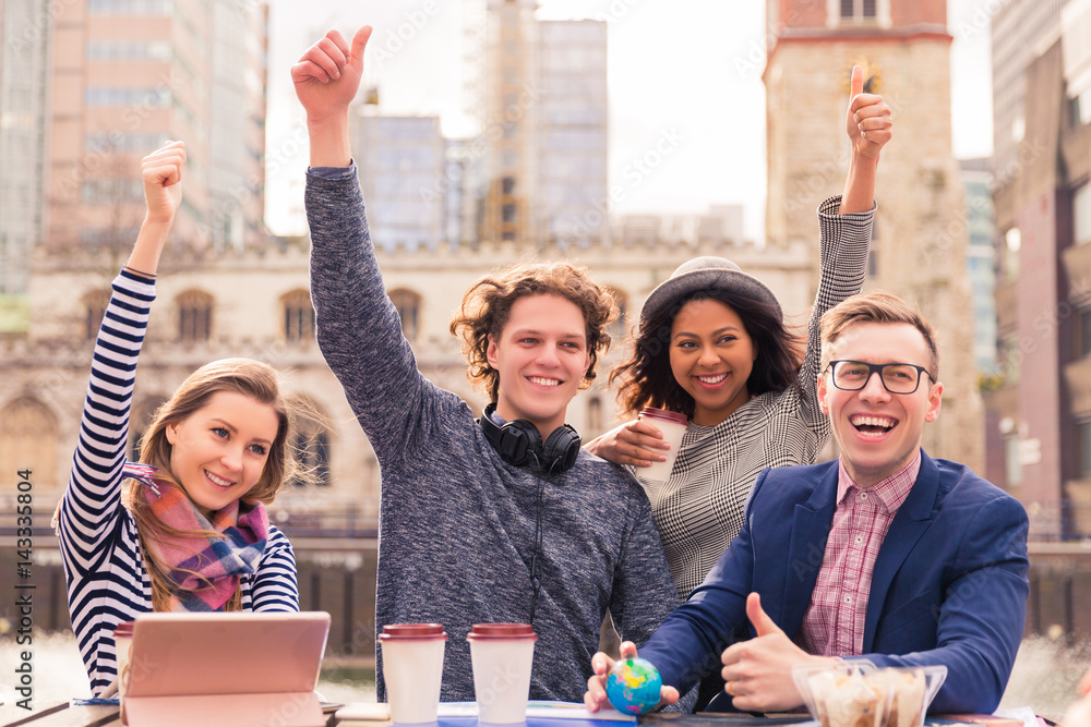 Beautiful, cheerful, smiling students sit in time of a break with the ...