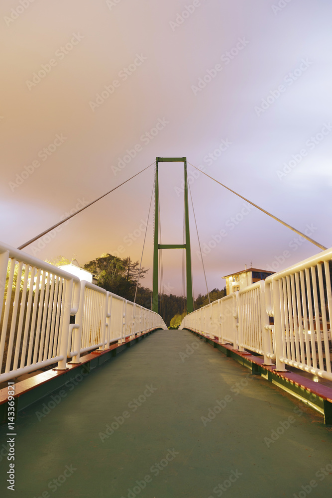 Pedestrian bridge of Pobena at night, over the river Barbadun, in the ...
