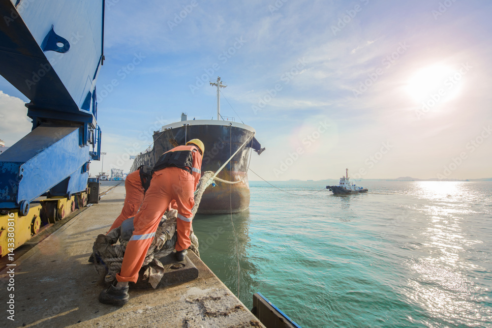 mooring gangs attending release the lines on the ship departure from ...