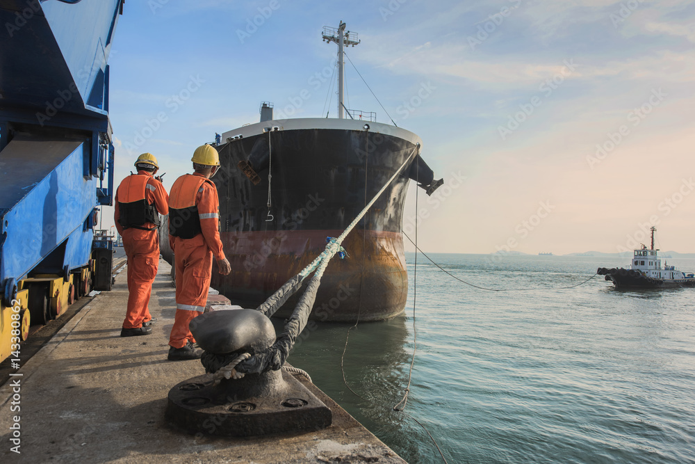 mooring gangs attending to un-berth the ship on sailing departure from ...