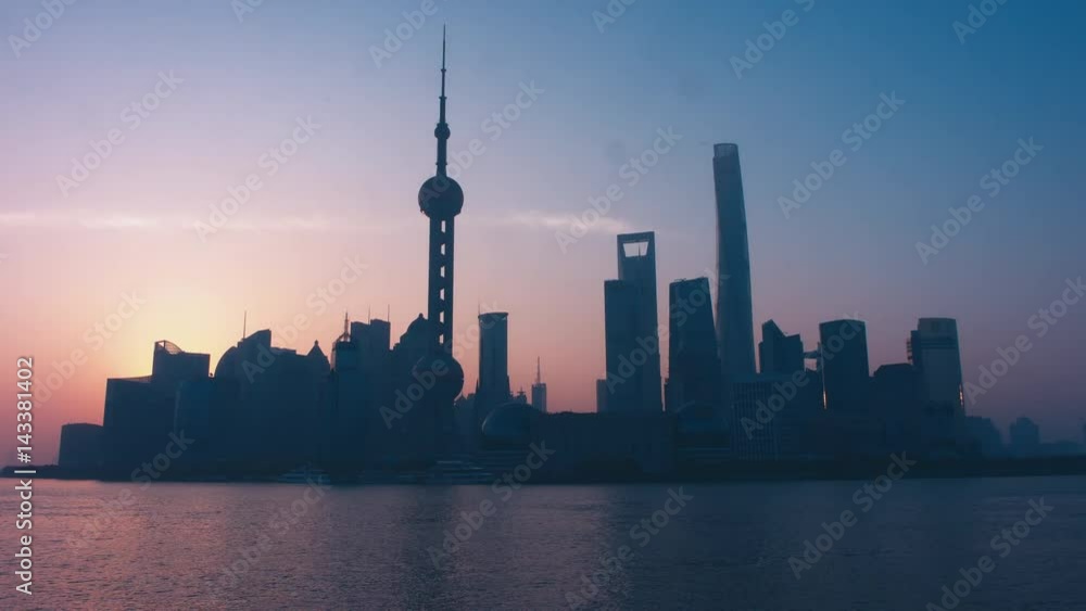 Sun in showing from behind the building in Shanghai central business ...