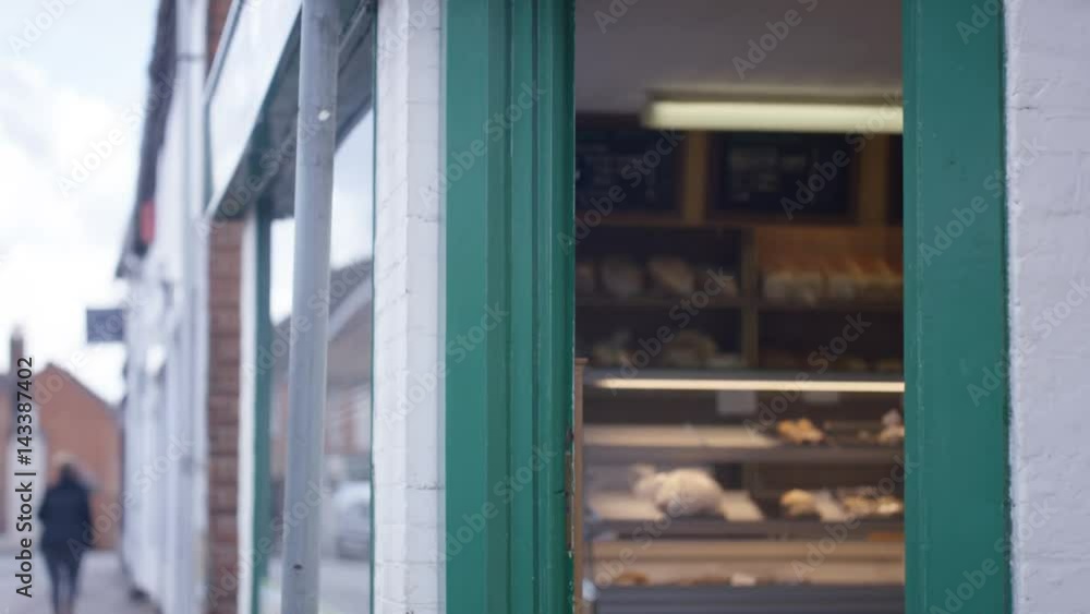 Happy Bakery owner holds up a sign to show she is open for business ...