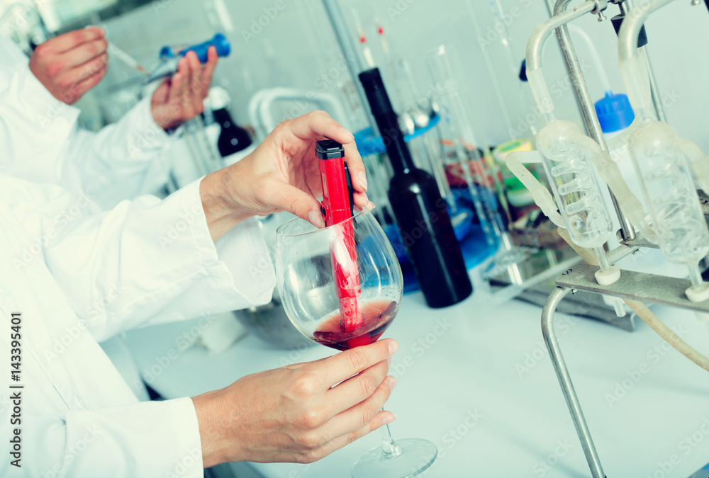 Wine being checked on component saturation in laboratory Stock Photo ...