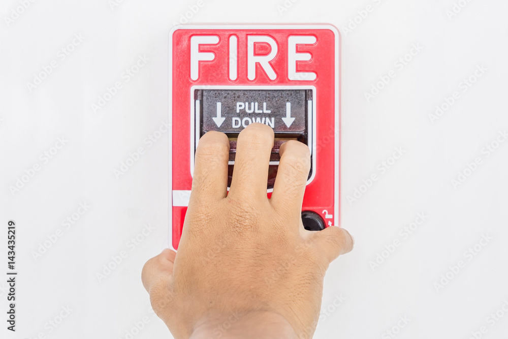 Hand of man pulling fire alarm switch on the white wall as background ...