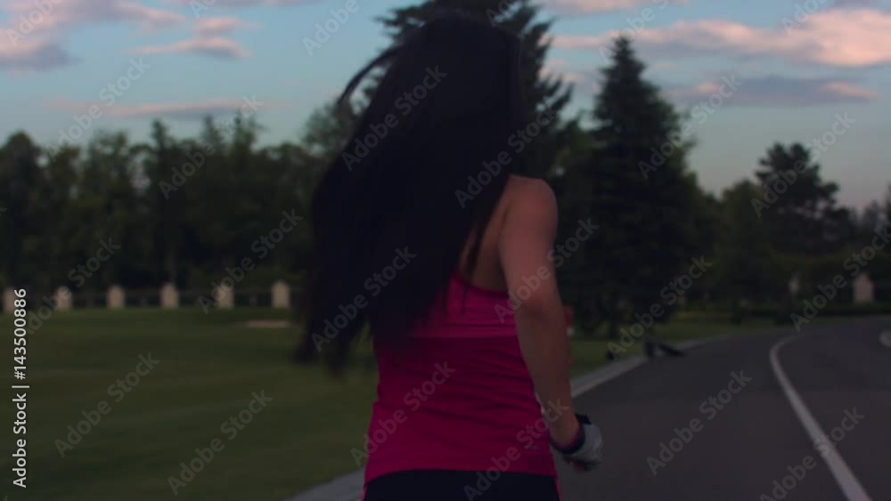 Fitness woman running away on road. Back view of fitness woman jogging ...