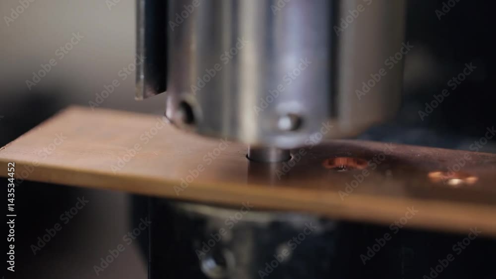 Automatic press makes holes in copper plate on engereering factory ...