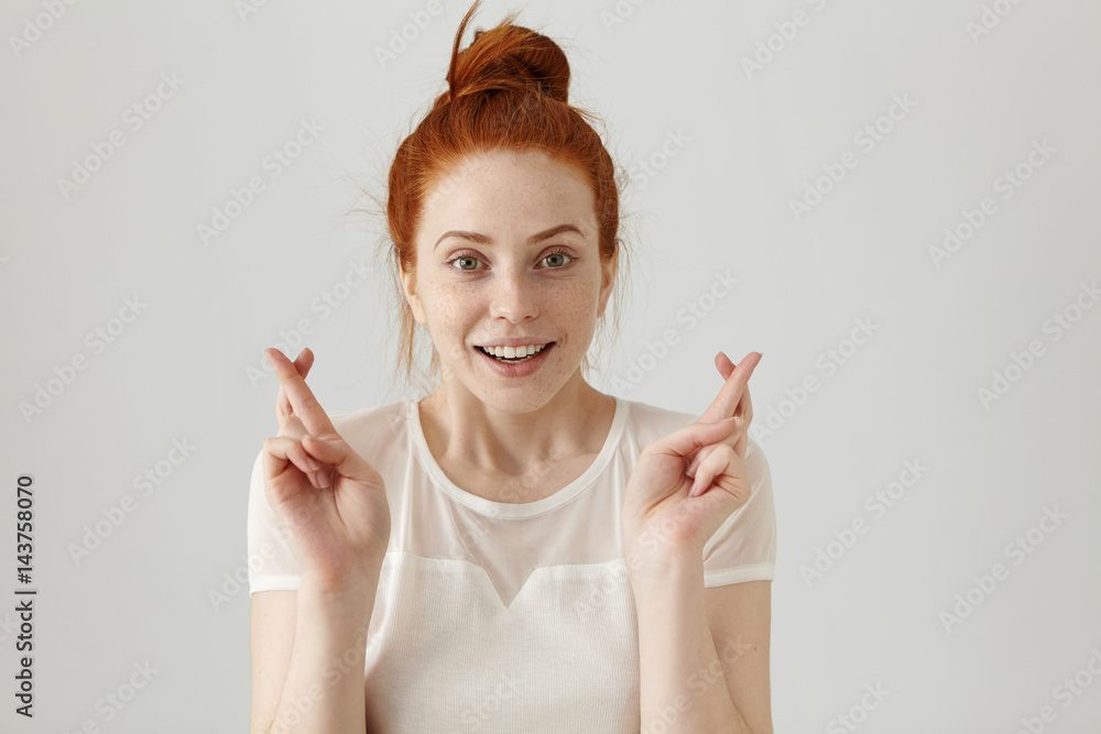 Body language. Superstitious teenager girl with ginger hair and pretty ...