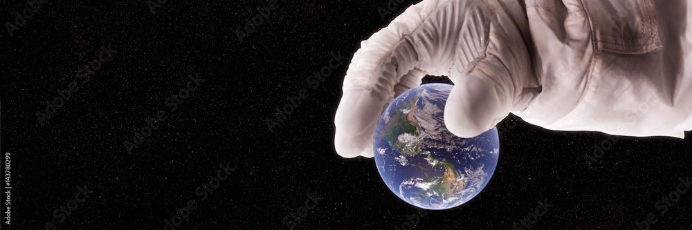 astronaut’s hand holding planet Earth in deep space - conceptual ...