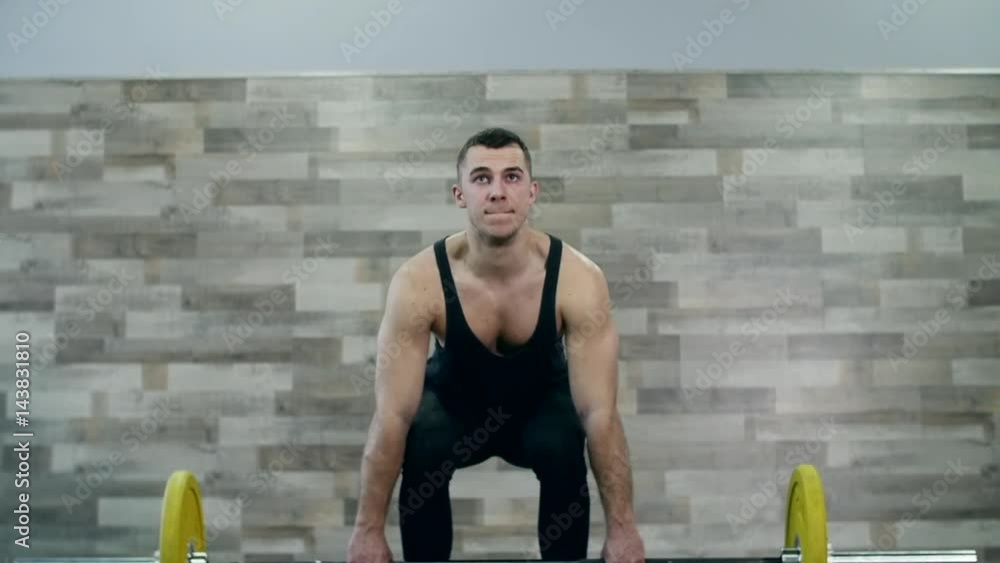 Medium shot slow mo tilt-down tilt-up men exercising and lifting ...