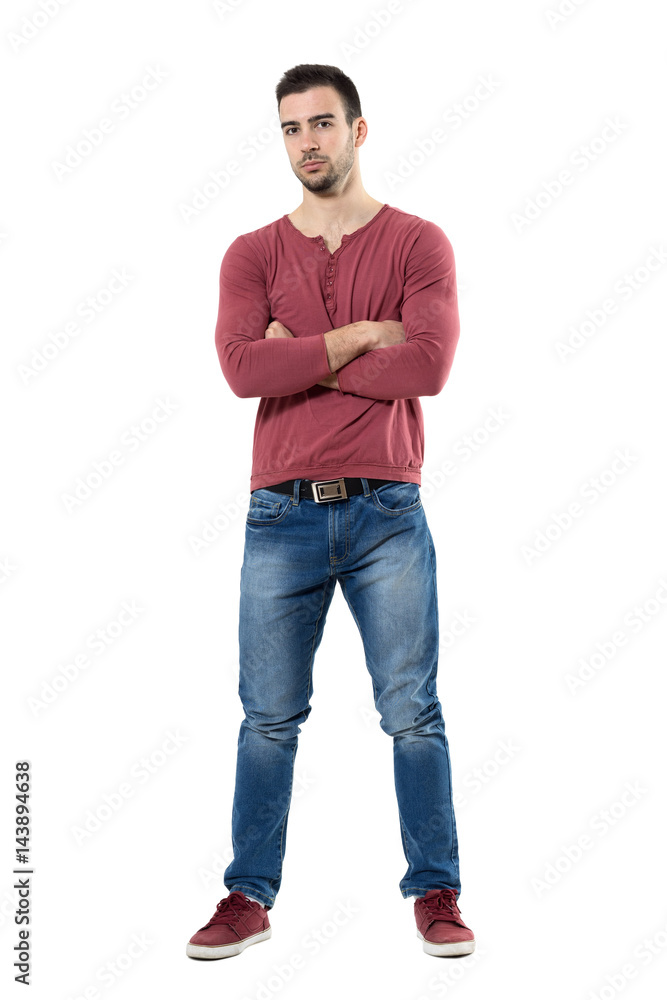 Confident young fashion male model with folded hands looking at camera ...