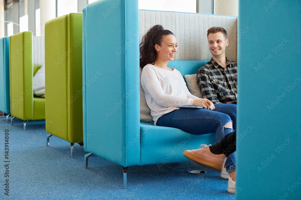 University students relaxing in modern cubicle seating area Stock Photo ...
