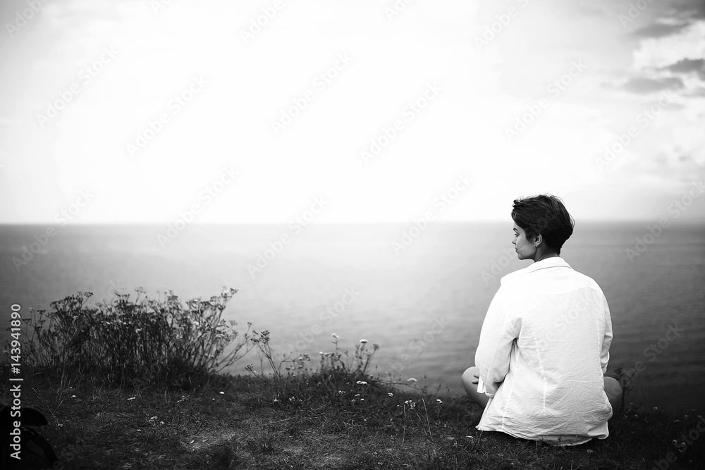 Sad girl alone sits on the beach and misses Stock Photo | Adobe Stock