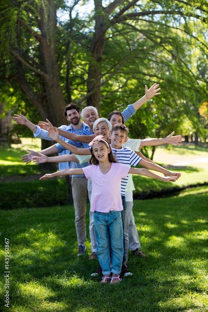 Multi generation family standing in a row with arms outstretched Stock ...